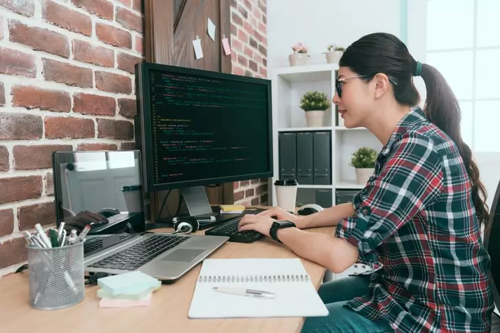 Mujer en la computadora, codificando.