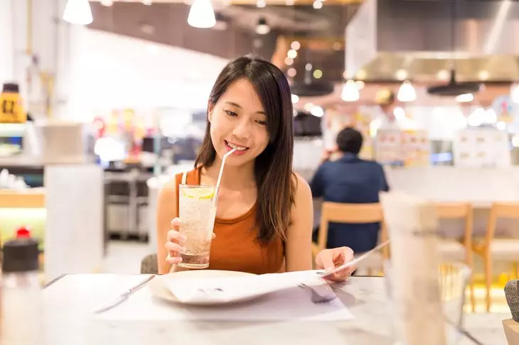 在餐館喝飲料的女人