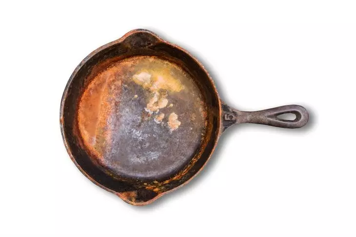 Rusty cast iron skillet.