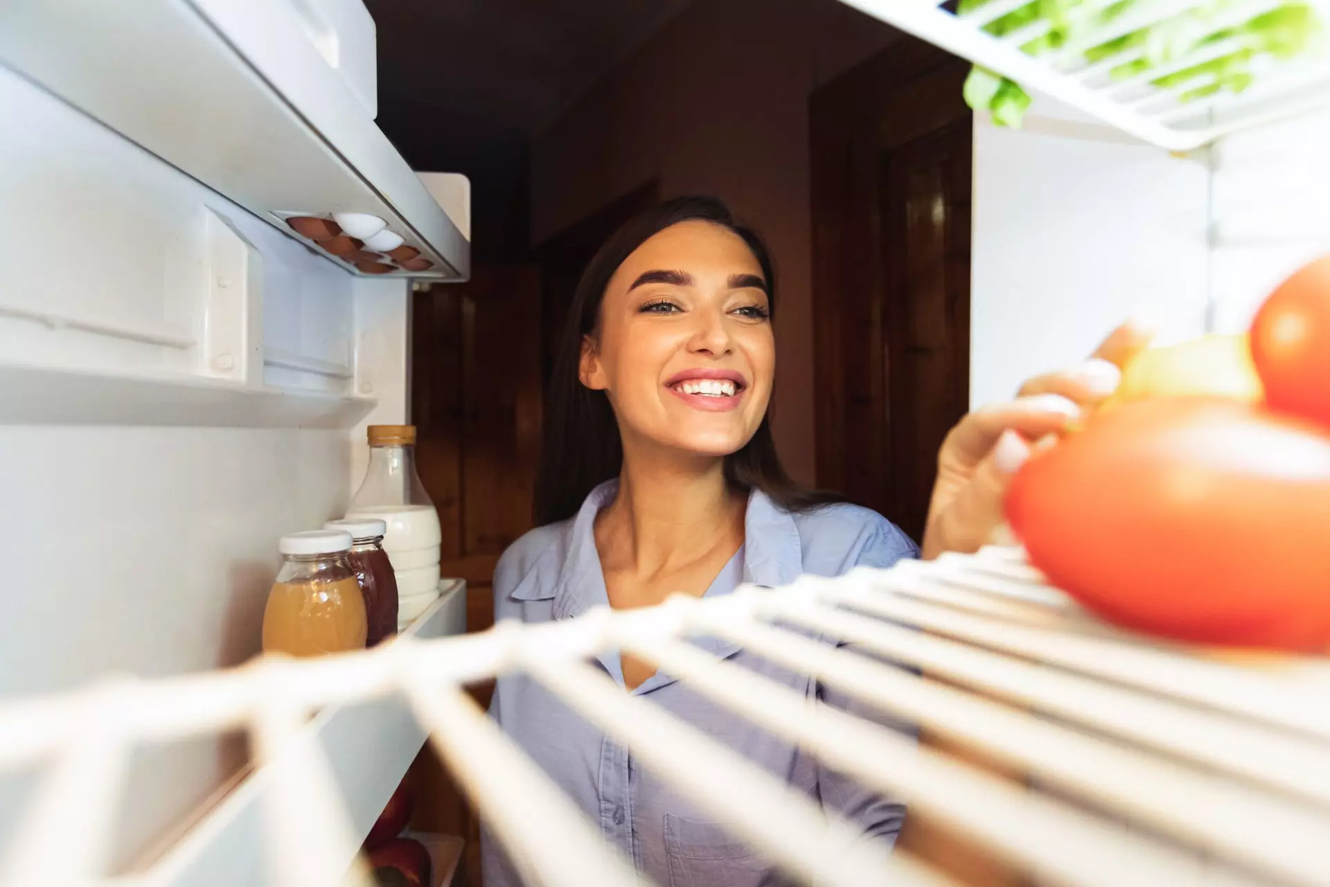 Malipayon nga babaye nga nagtan-aw sa refrigerator